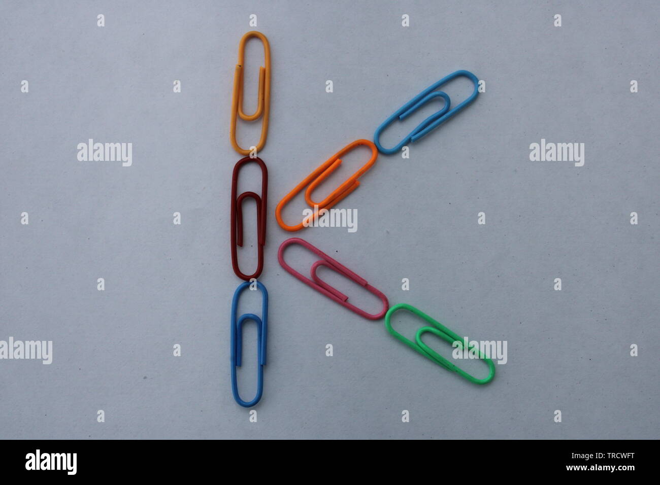 Letter K made with colorful paper clips on white background Stock Photo ...