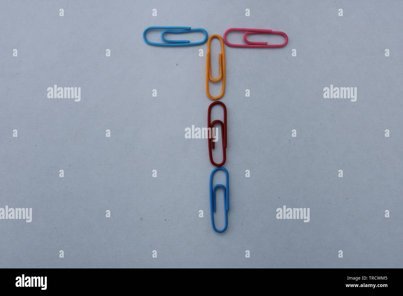Letter T made with colorful paper clips on white background Stock Photo ...