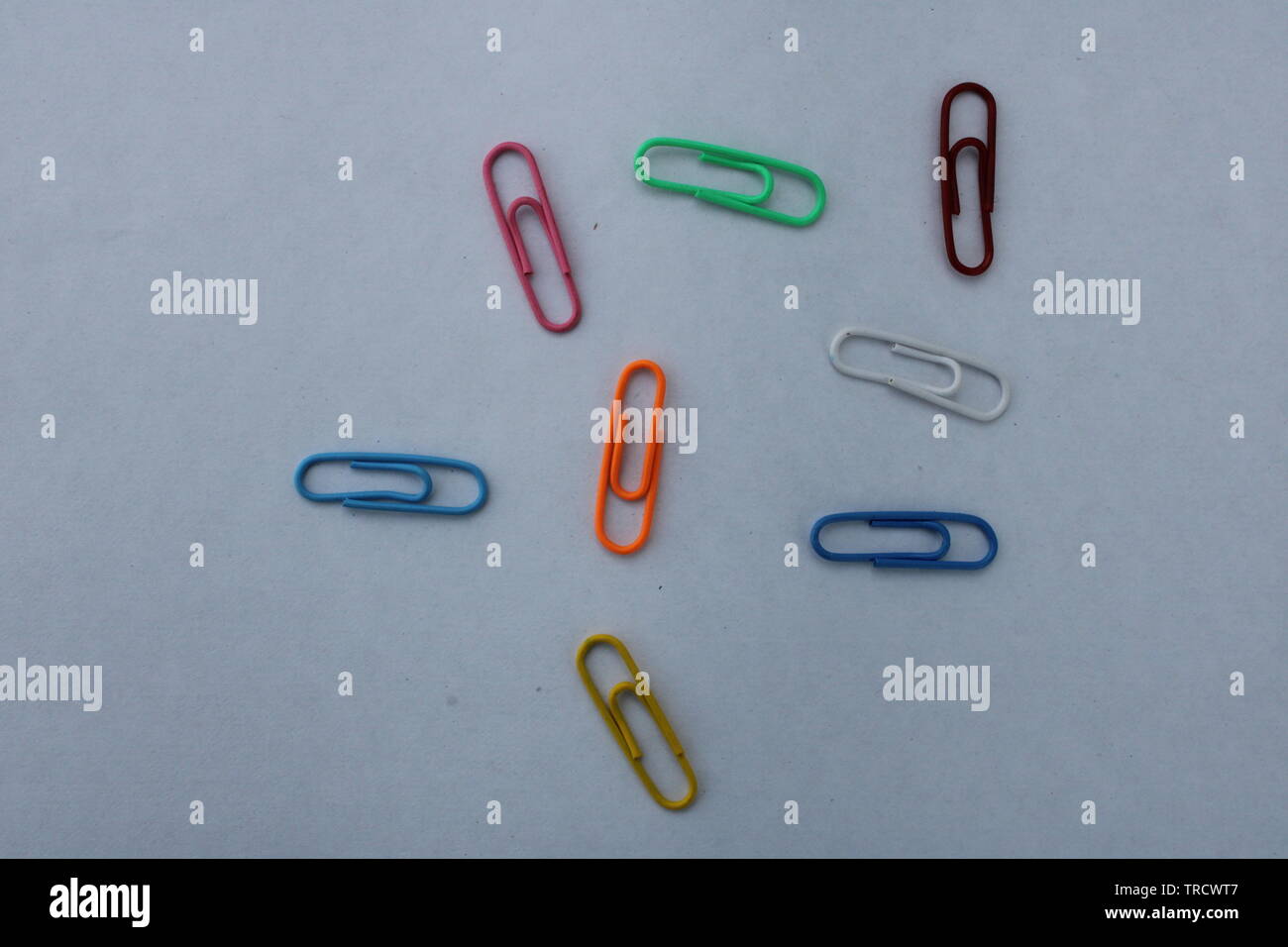Colorful paperclips on white background Stock Photo - Alamy