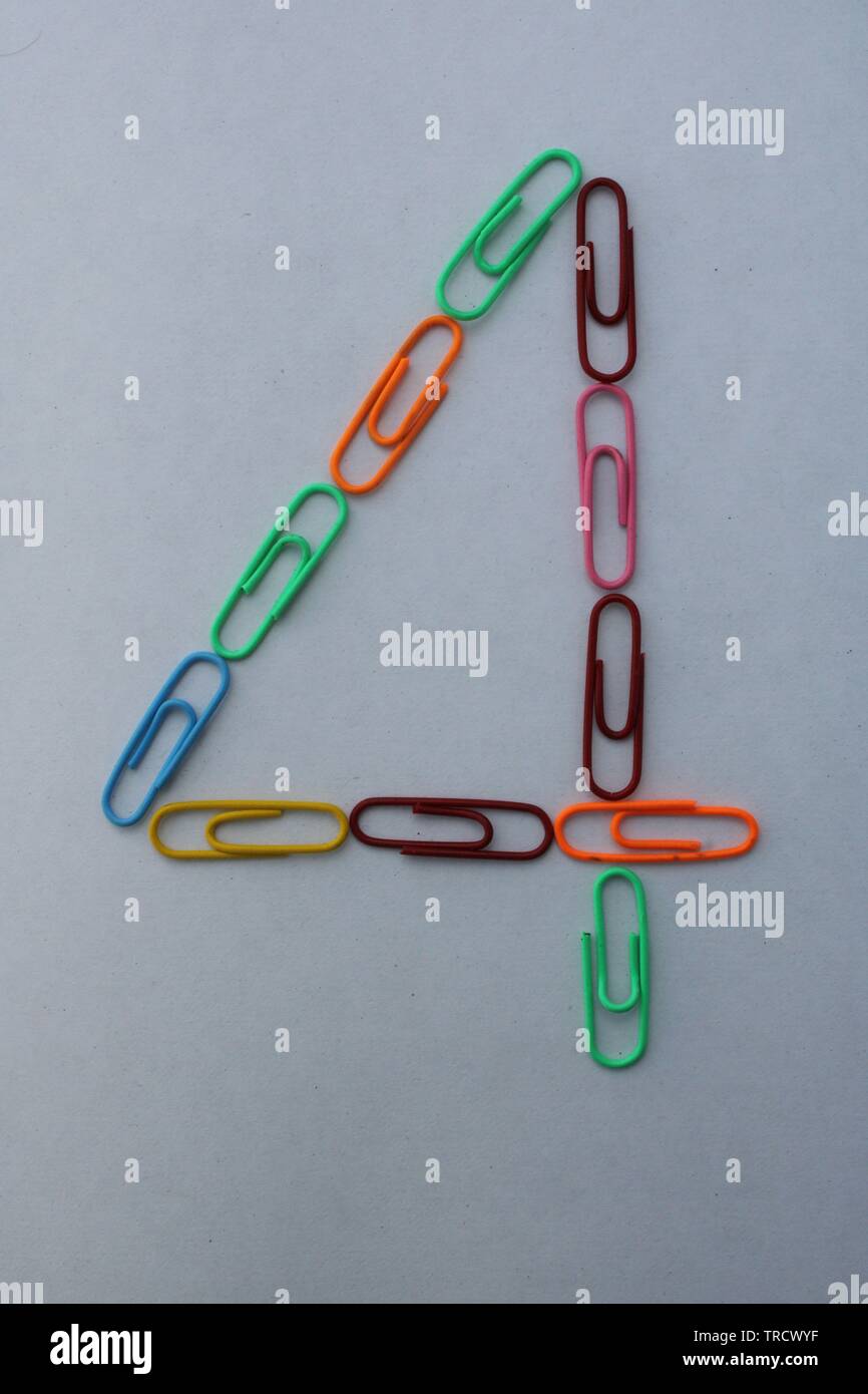 Number 4 made with colorful paper clips on white background Stock Photo ...