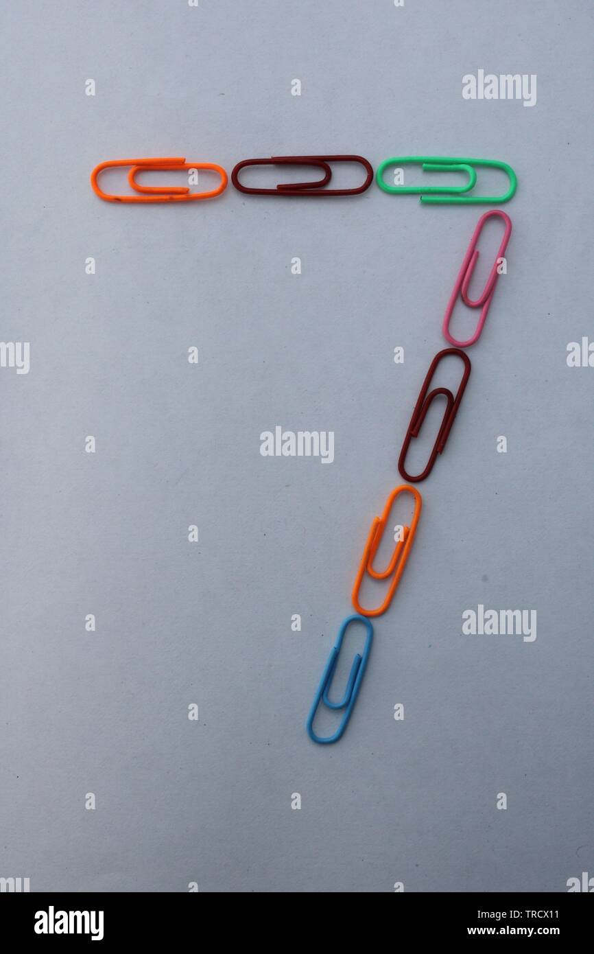 Number 7 made with colorful paper clips on white background Stock Photo ...