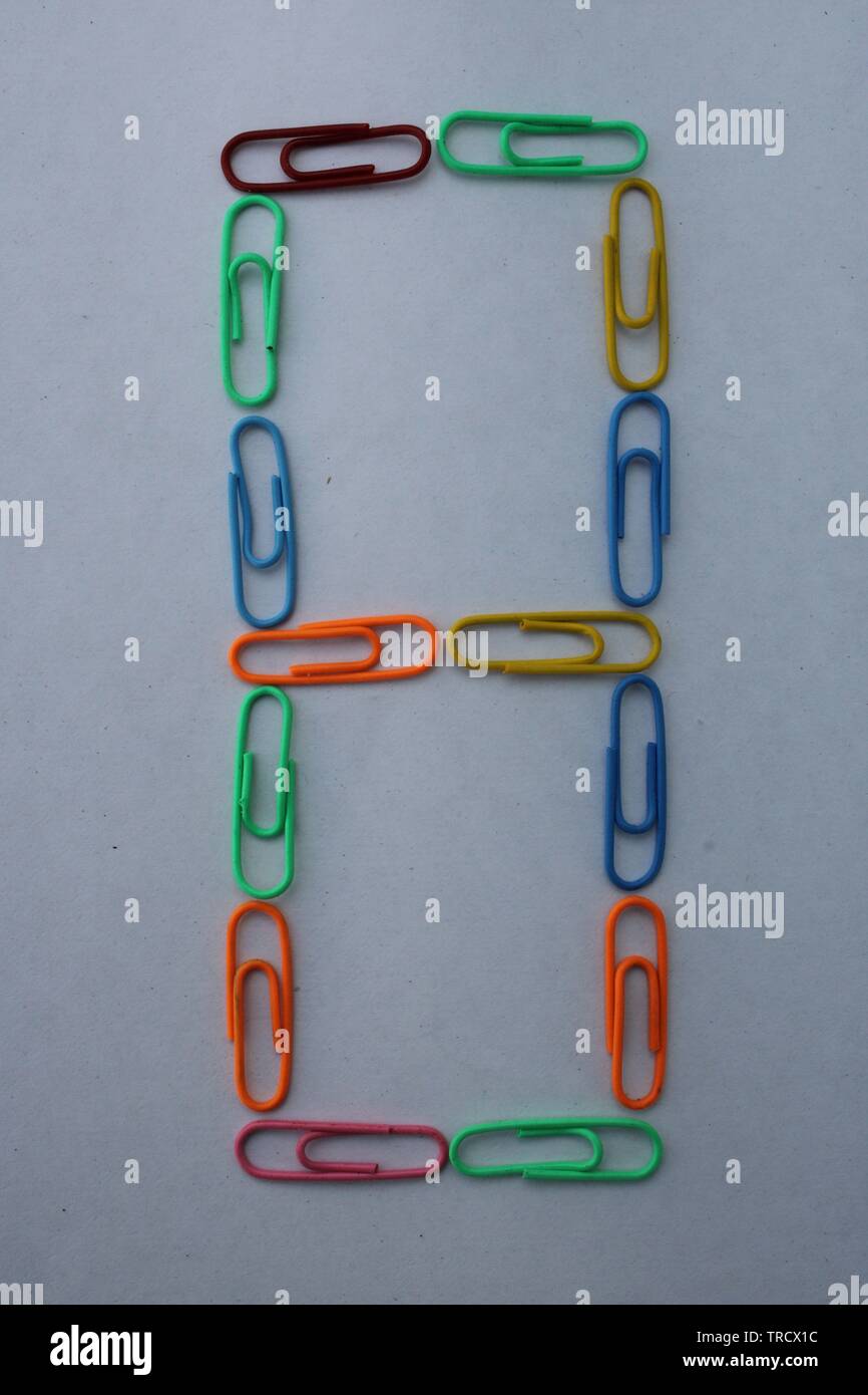 Number 8 made with colorful paper clips on white background Stock Photo ...