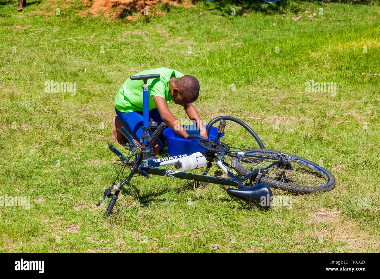 Harrismith, South Africa - October 18 2012: African Children fixing a ...