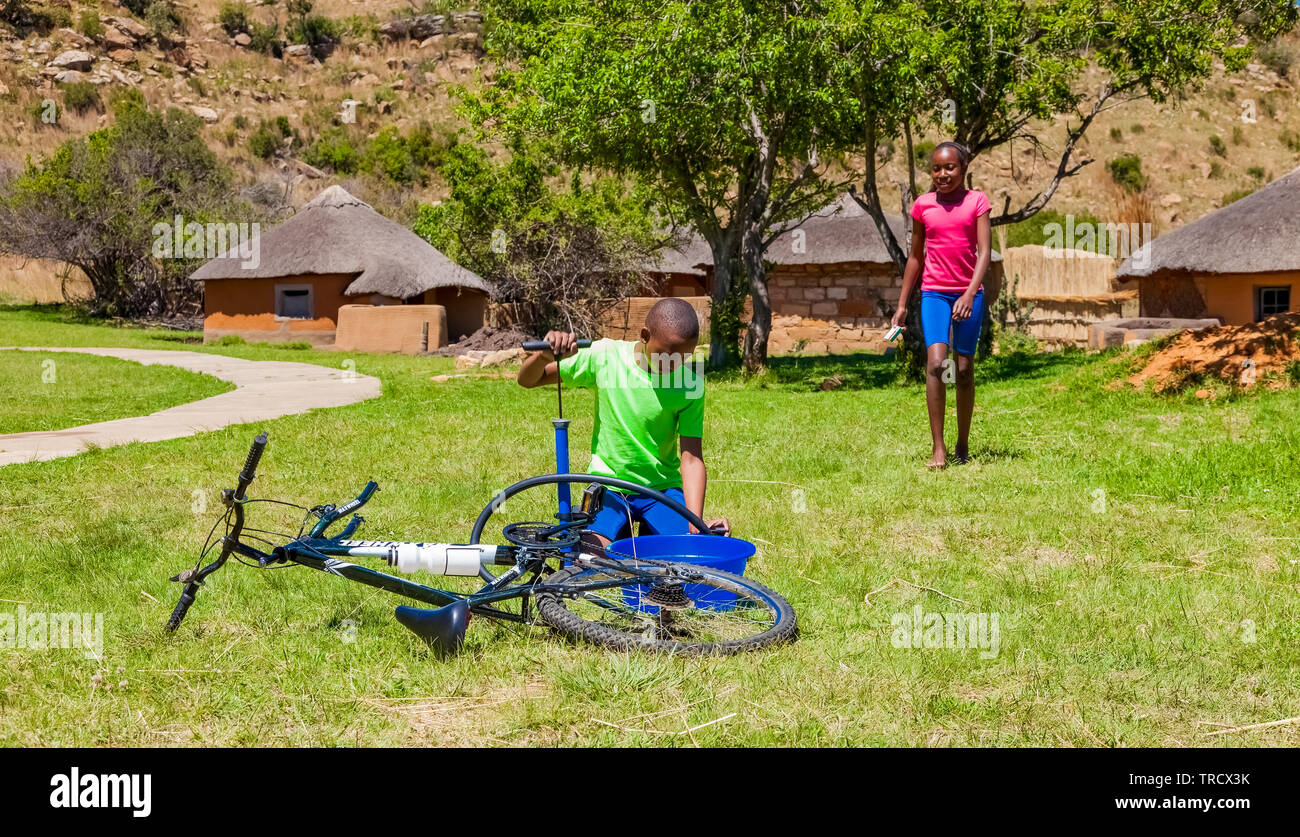 Harrismith, South Africa - October 18 2012: African Children fixing a ...