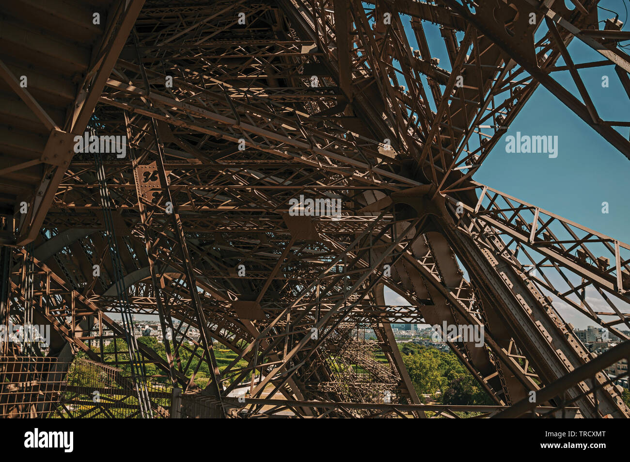 View of internal iron structure of the Eiffel Tower, with sunny blue ...