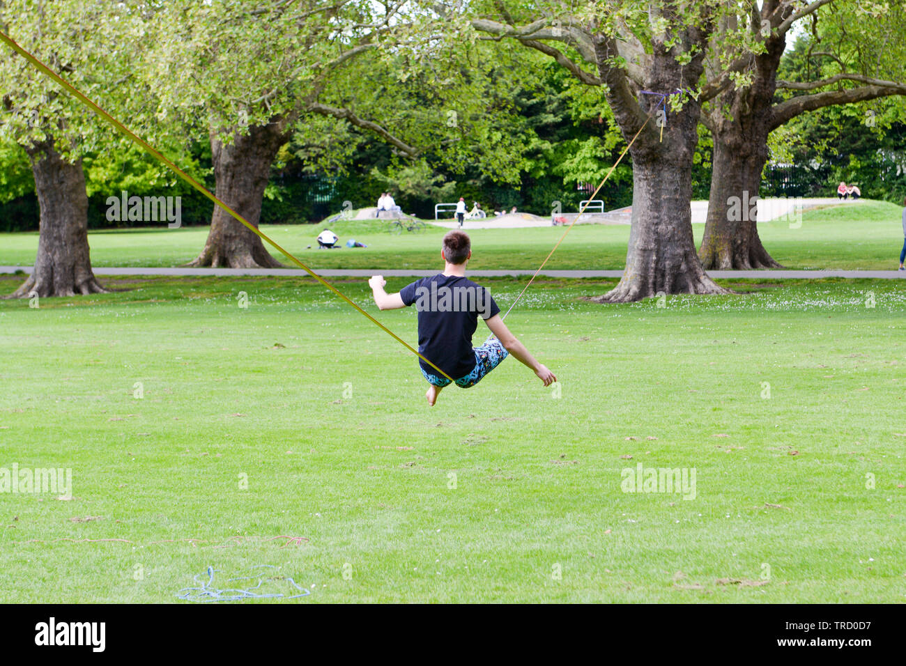cambridge uk 2019-05-12. A male practises balancing on a slack line ...