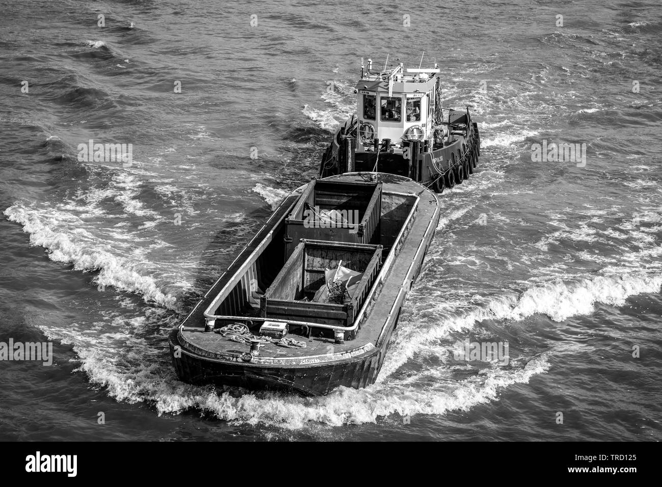 Tug boat pushing a waste barge on the river Thames in London Stock ...
