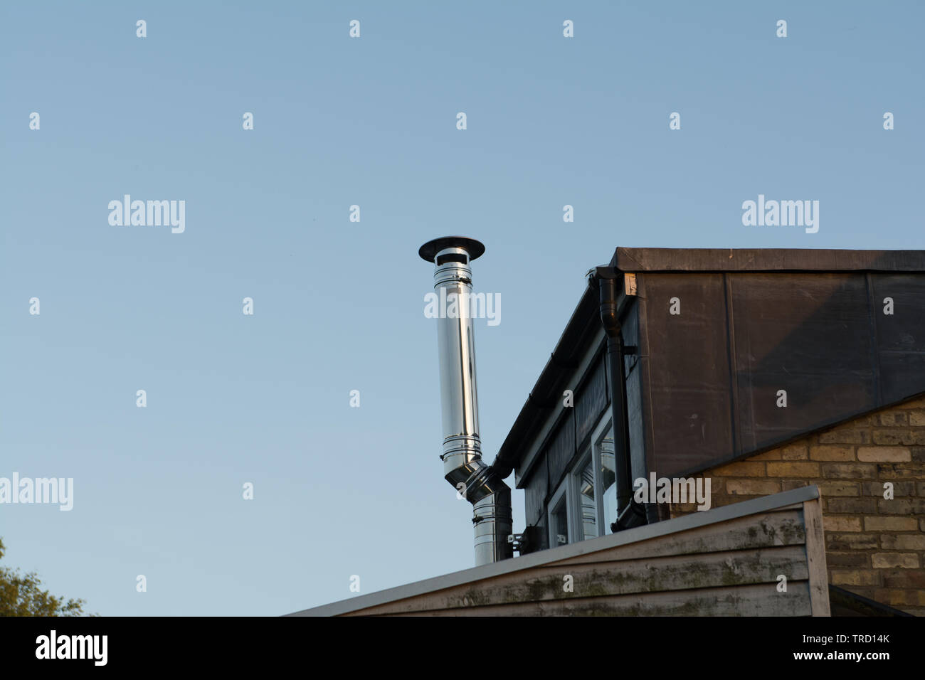 Stainless steel extration chimney mounted to side of house Stock Photo ...