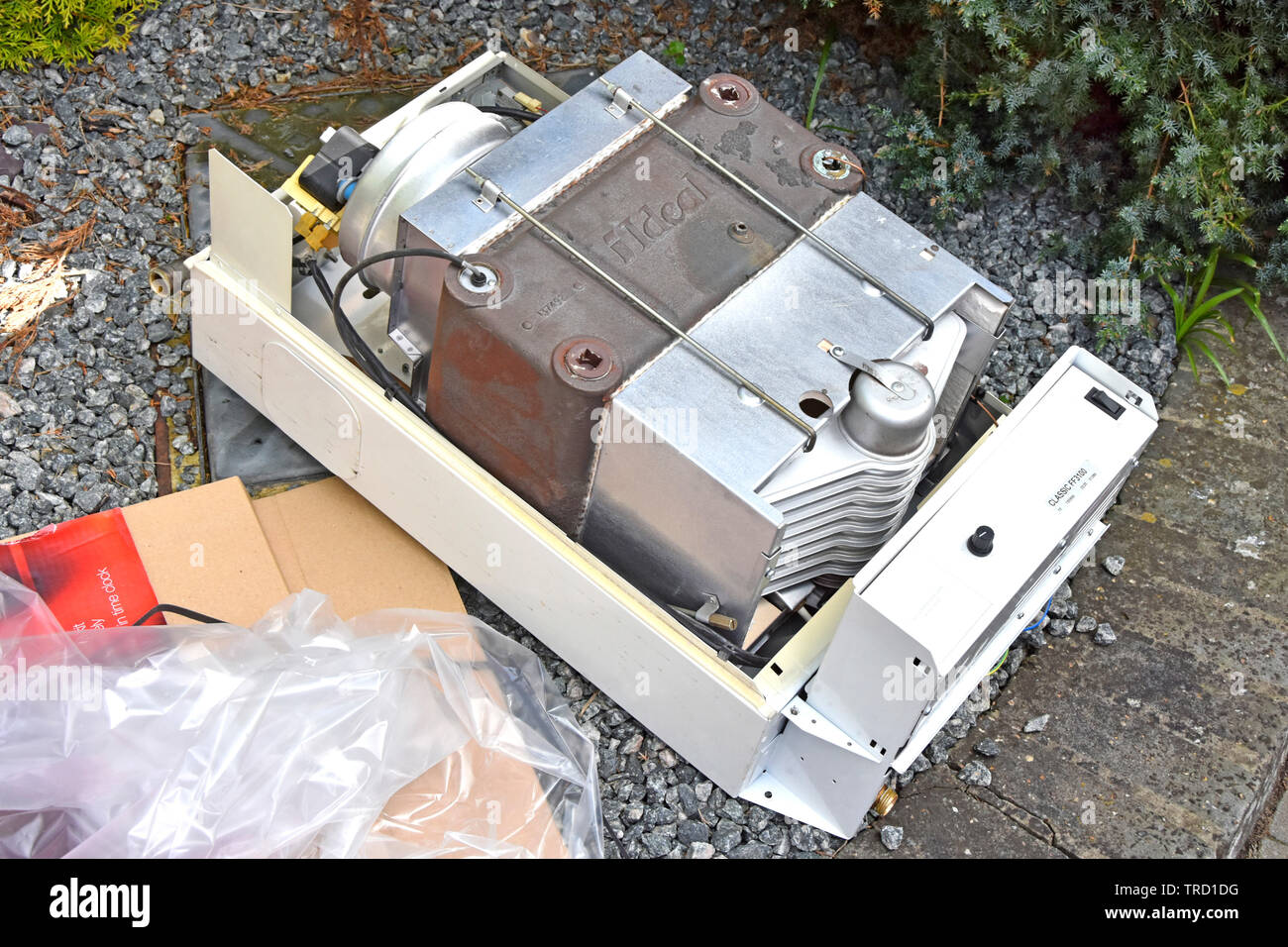 Old broken domestic gas central heating boiler & packaging from modern ...