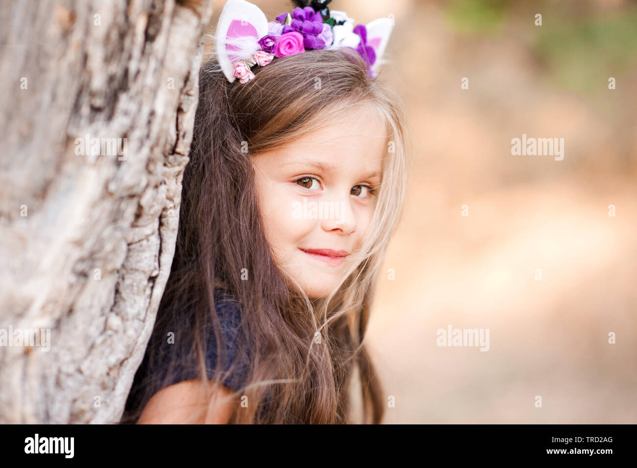 Smiling baby girl 4-5 year old posing outdoors. Looking at camera ...
