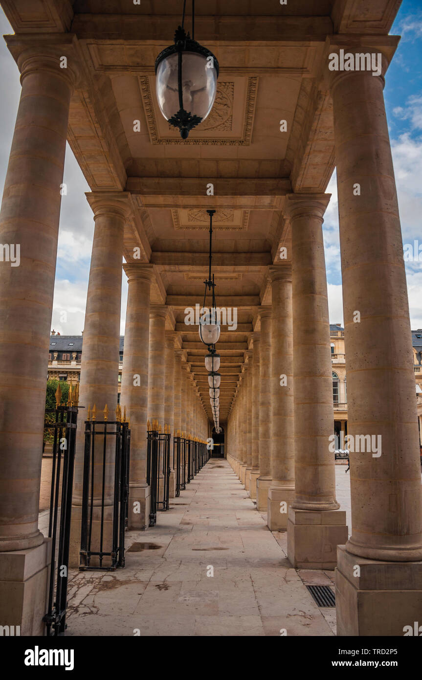 Pathway with marble colonnade between courtyards at the Palais-Royal in ...