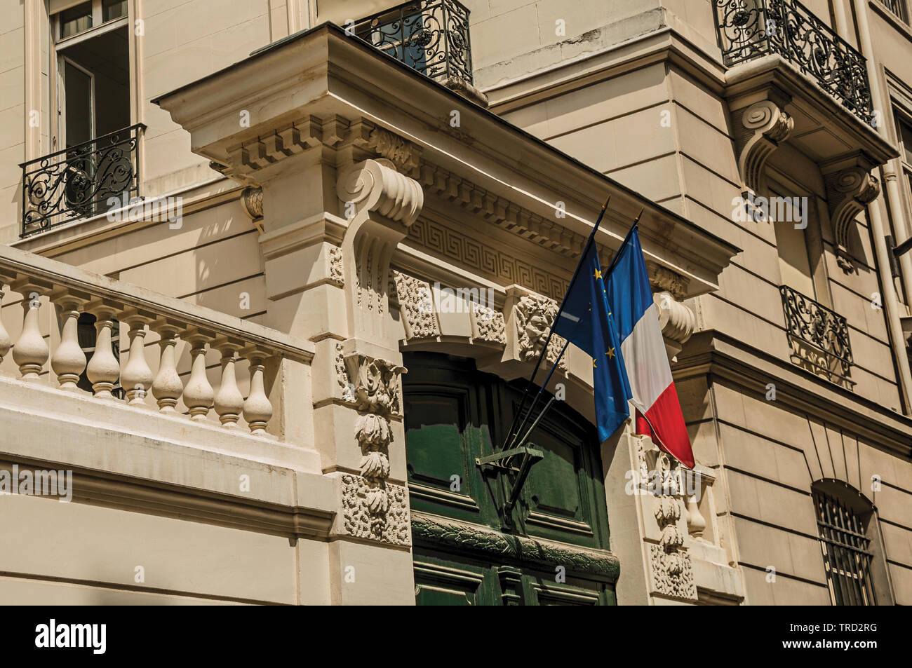 French flags above wooden door on an old building in a cloudy day at ...