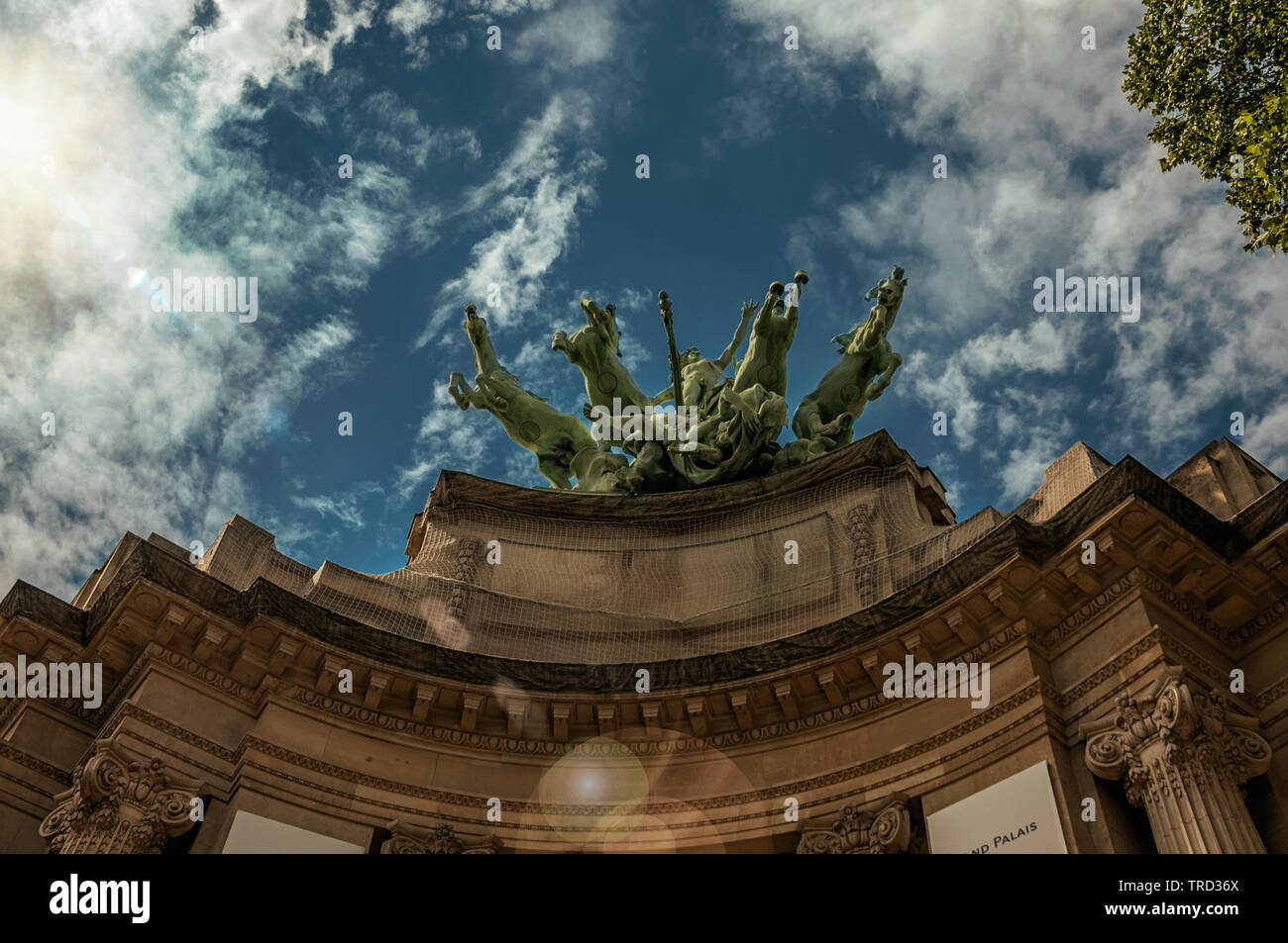 Bronze statue adorning the Grand Palais building top in a sunny day at ...