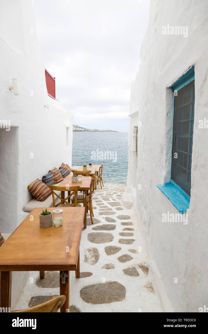 On the Greek Island of Mykonos, cobbled pathways with shop and ...