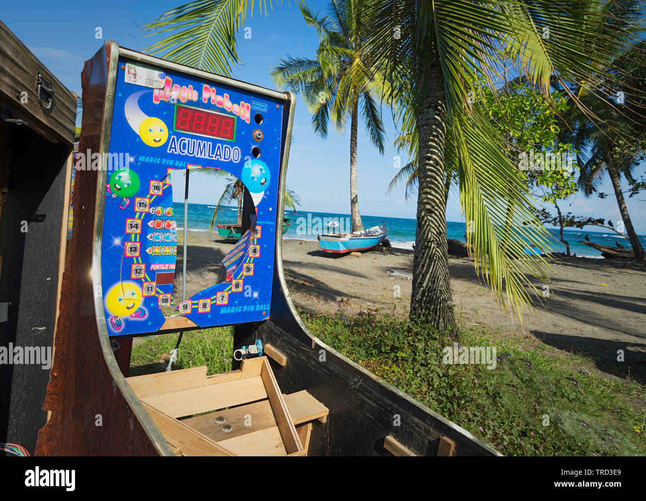 PINBALL MACHING ON THE TOPICAL BEACH WITH FISHING BOATS ON THE ...