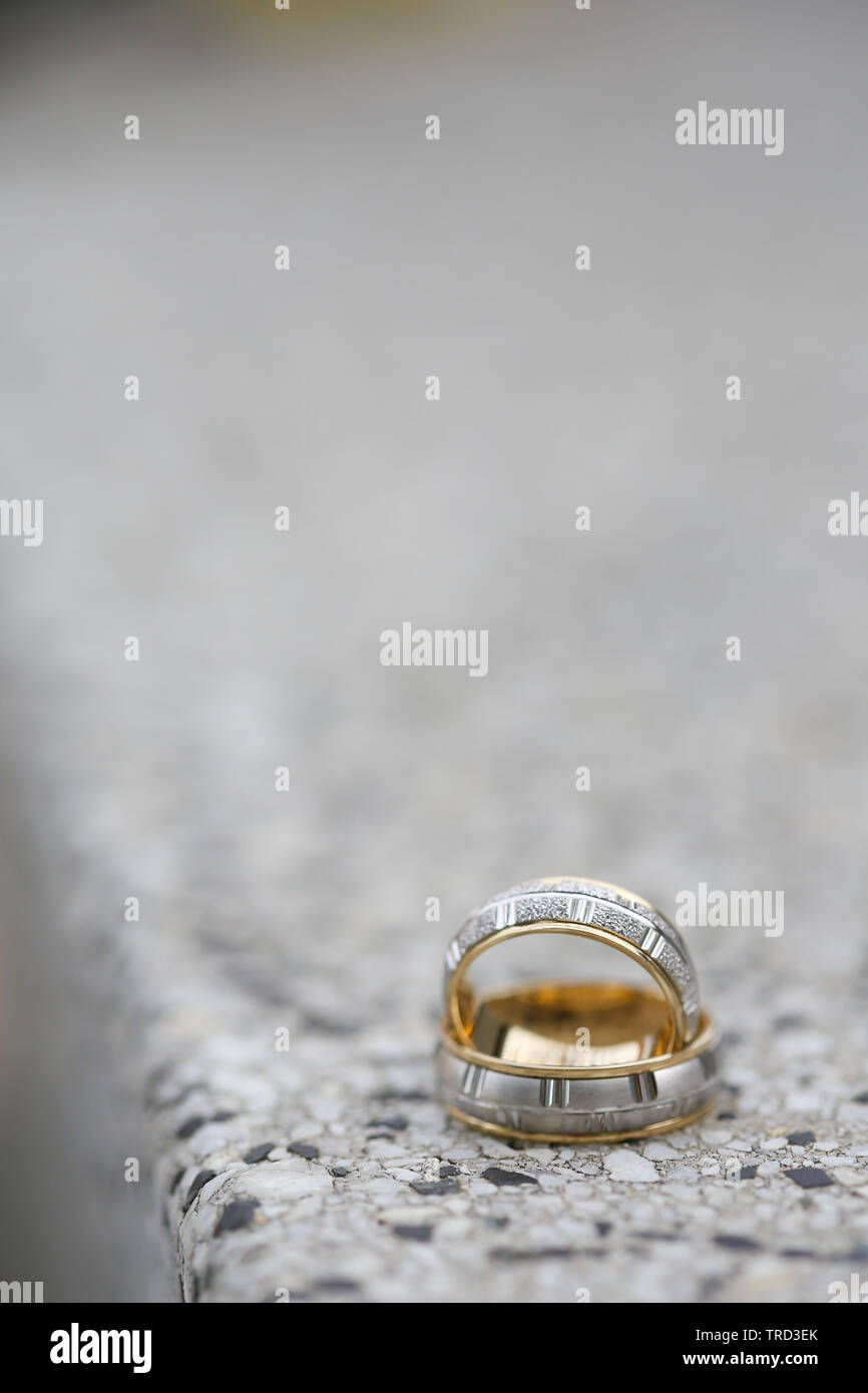 Golden wedding rings on a stone surface Stock Photo - Alamy