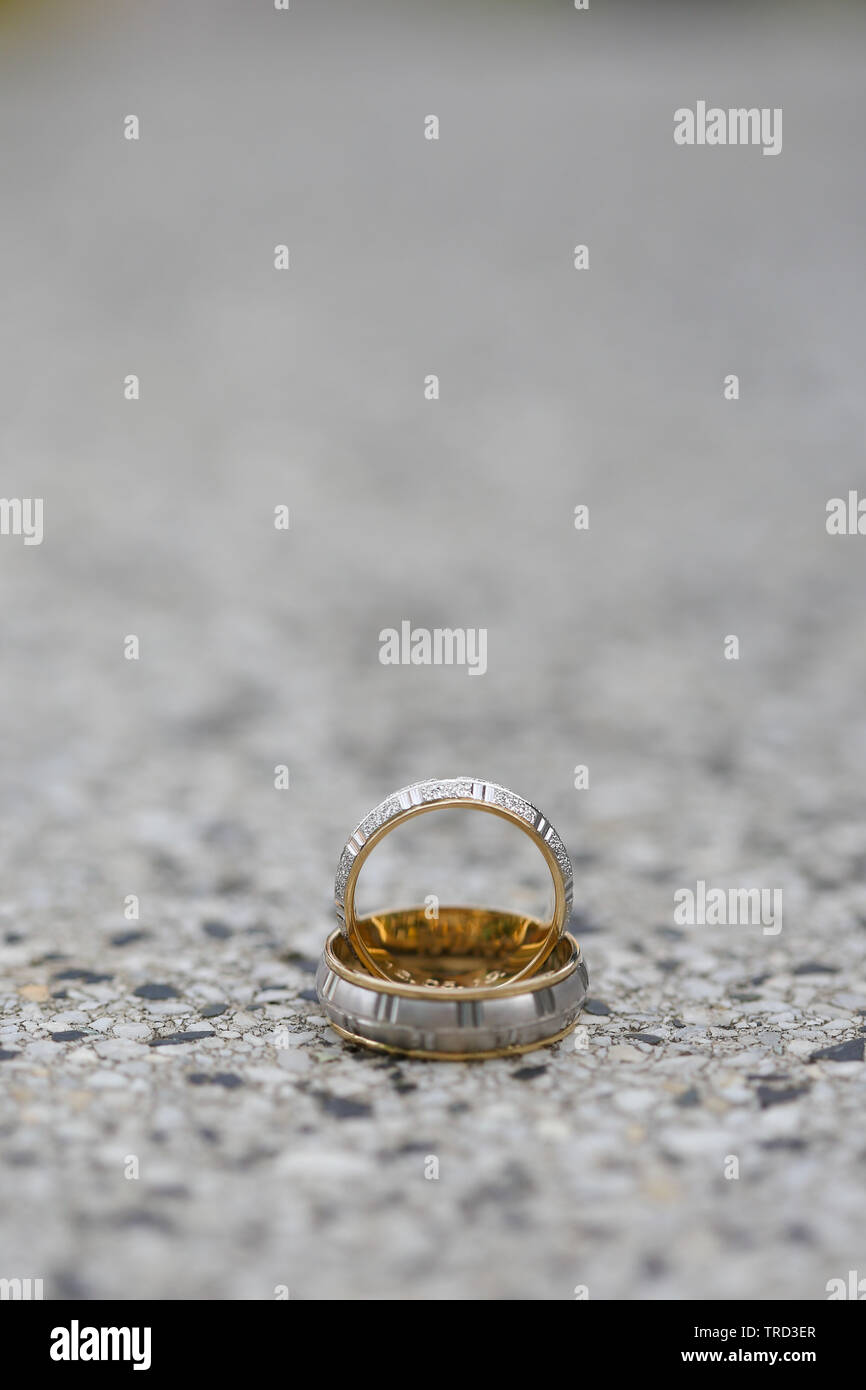 Golden wedding rings on a stone surface Stock Photo - Alamy