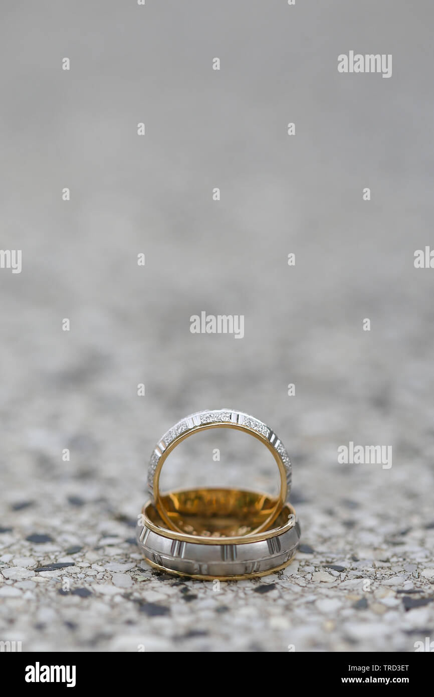 Golden wedding rings on a stone surface Stock Photo - Alamy
