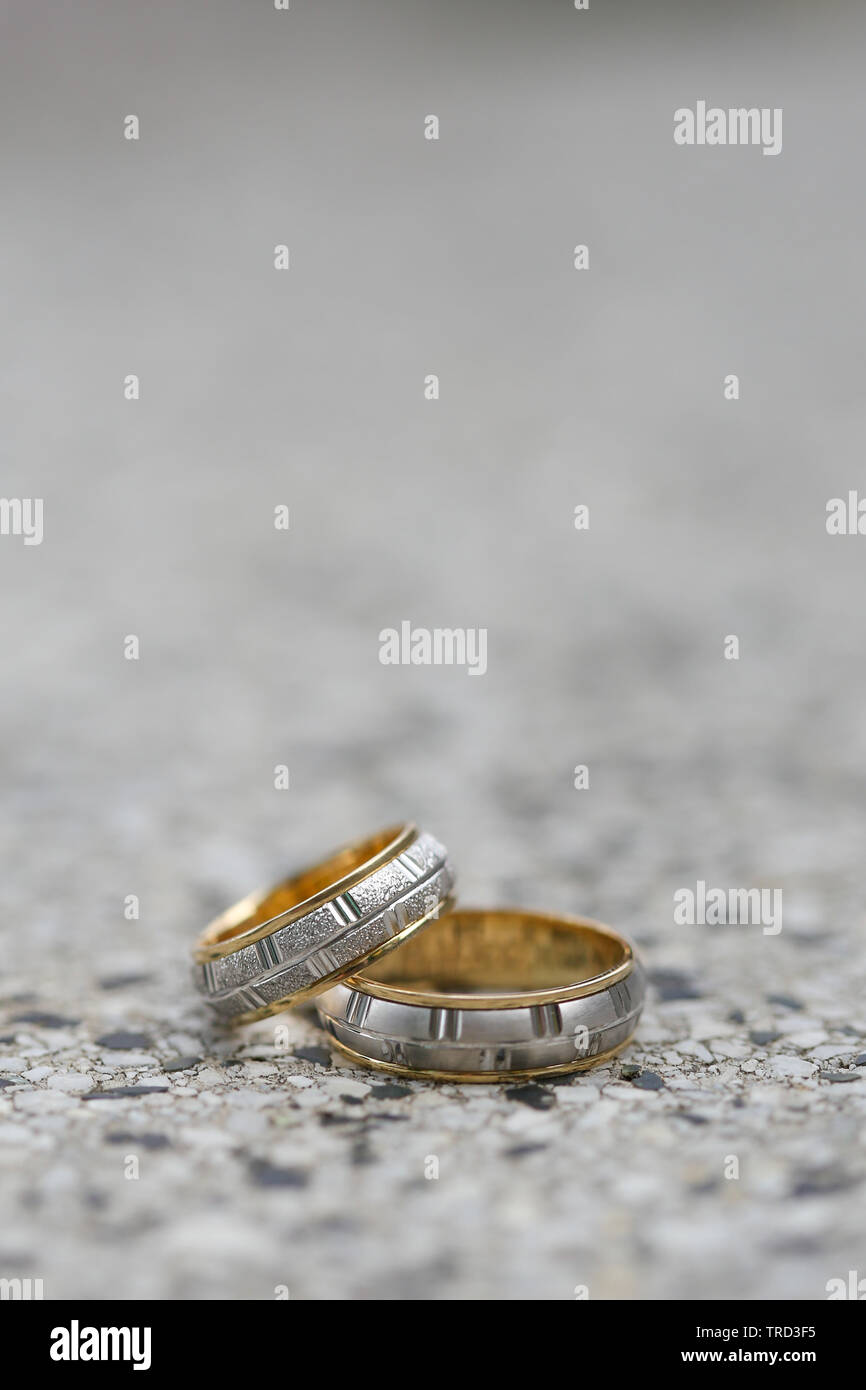 Golden wedding rings on a stone surface Stock Photo - Alamy