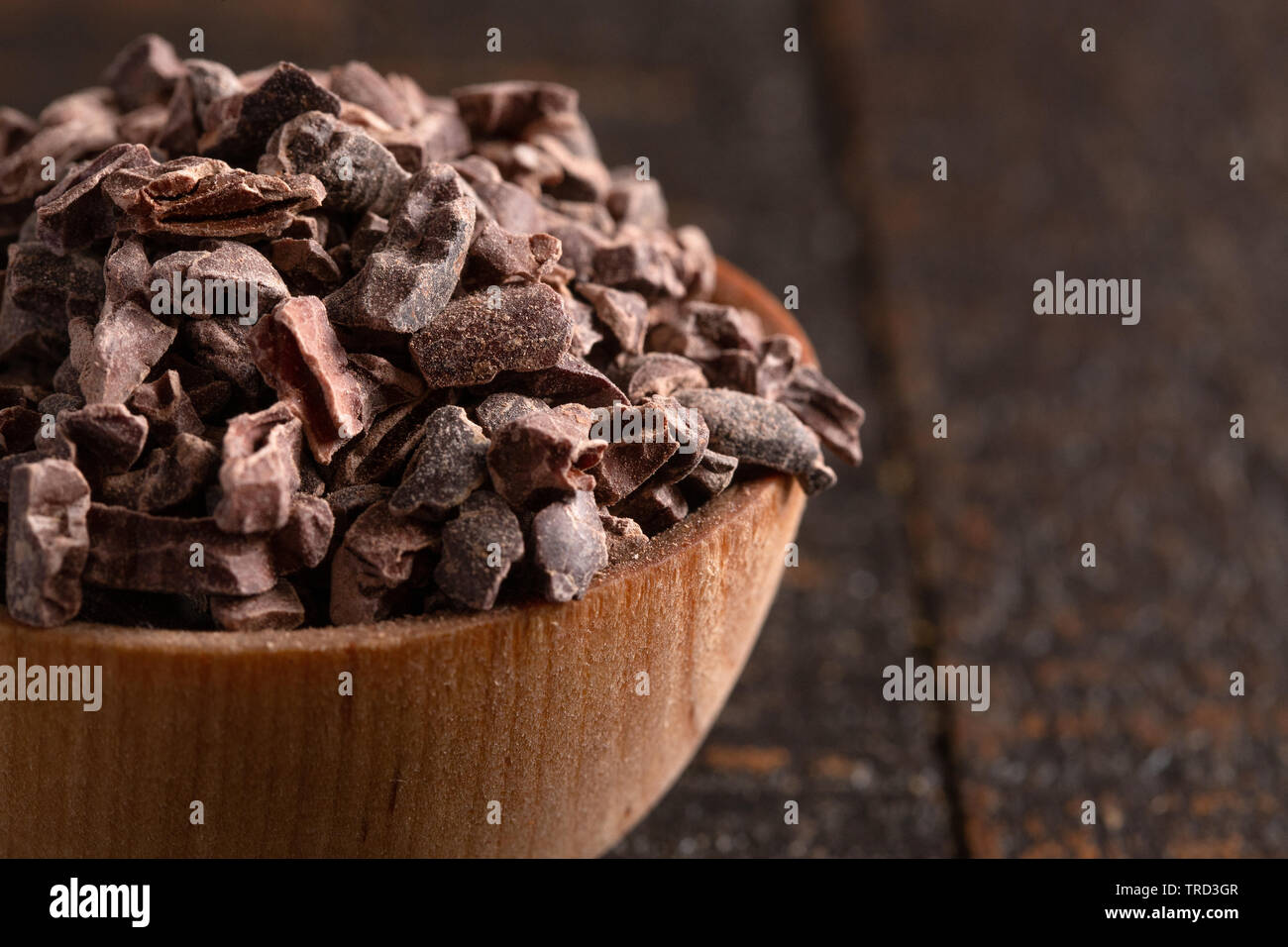 A Bowl of Raw Chocolate Nibs on a Rustic Wooden Table Stock Photo - Alamy