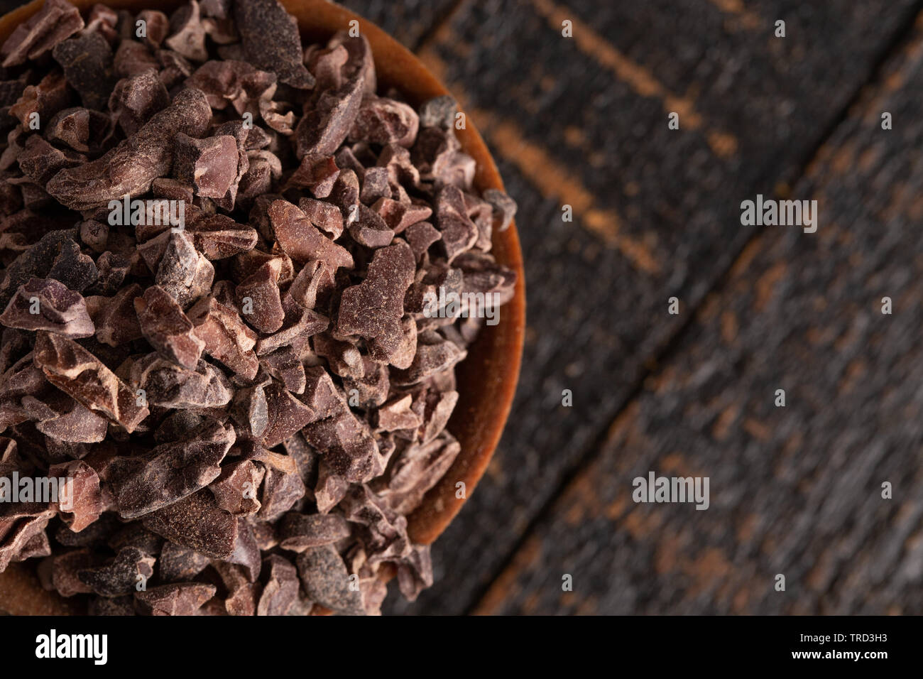 A Bowl of Raw Chocolate Nibs on a Rustic Wooden Table Stock Photo - Alamy