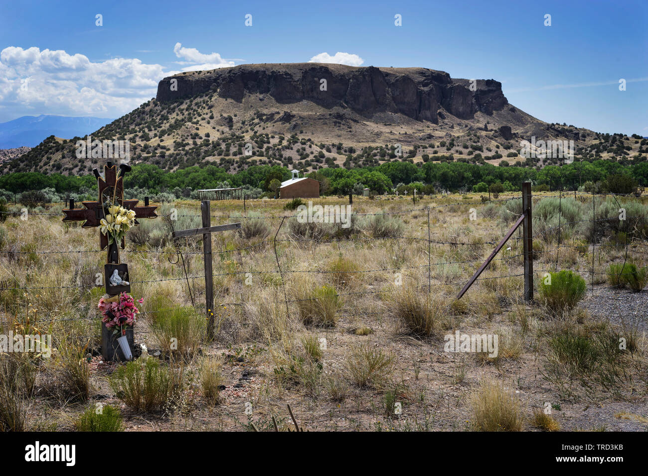 BLACK MESA WITH BARBED FENCE AND CROSSES SURROUNDING THE CHURCH AND ...