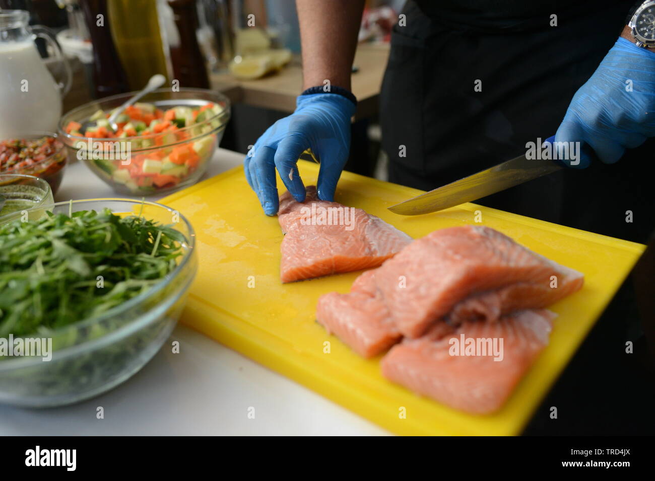 Man cuts fish pieces knife hi-res stock photography and images - Alamy