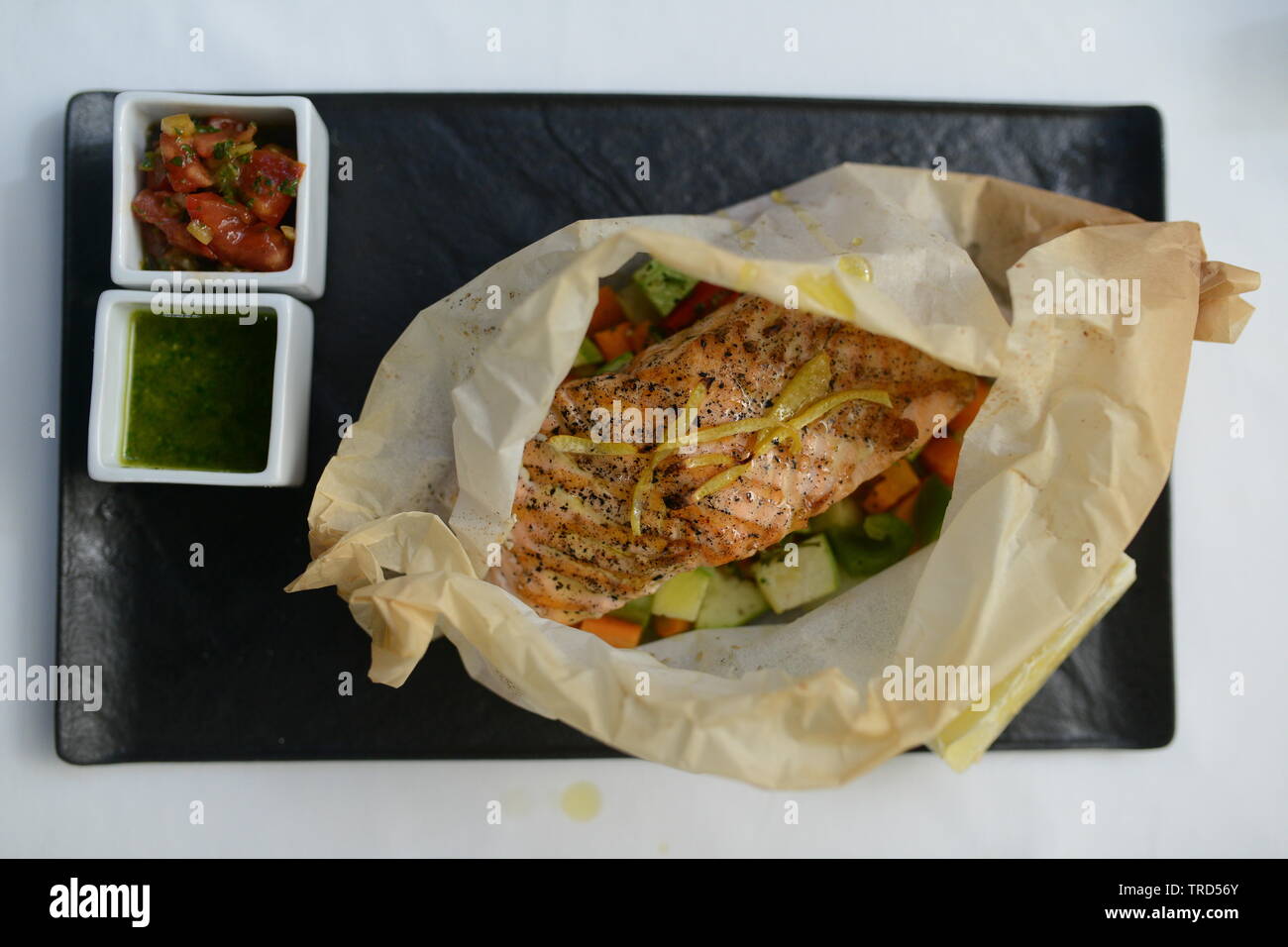 Served fish fillets with vegetables in a restaurant Stock Photo - Alamy