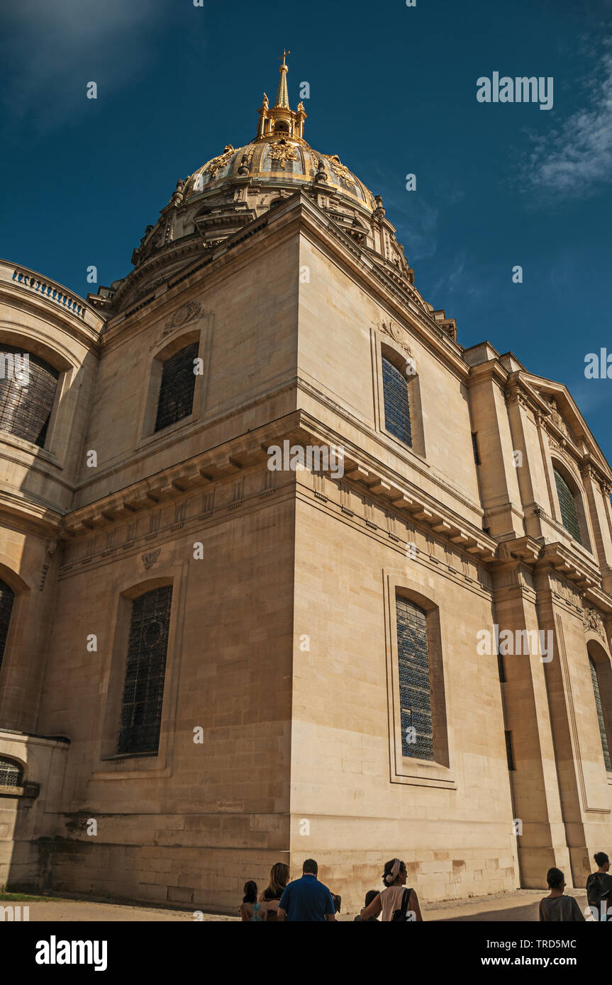 Side facade and golden dome of Les Invalides Palace with a sunny blue ...