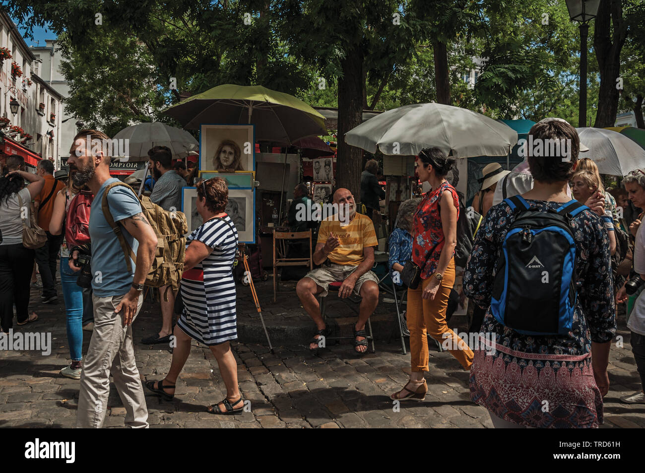 People and artists at the art fair of Montmartre in Paris. One of the ...