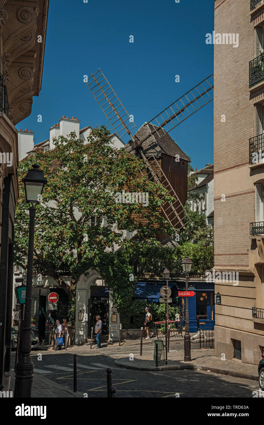 Old restaurant with windmill in a street of Montmartre at Paris. One of the most impressive ...