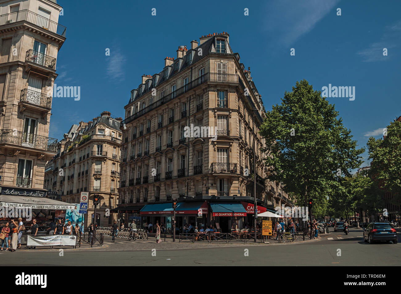 People, building and blue sky on street in Paris City Center. One of ...