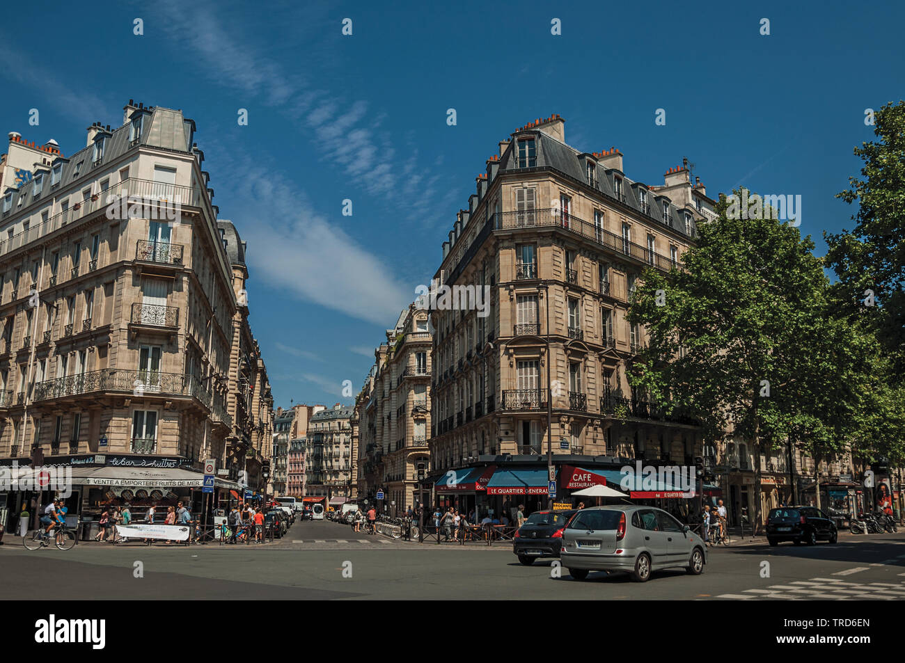 People, building and blue sky on street in Paris City Center. One of ...
