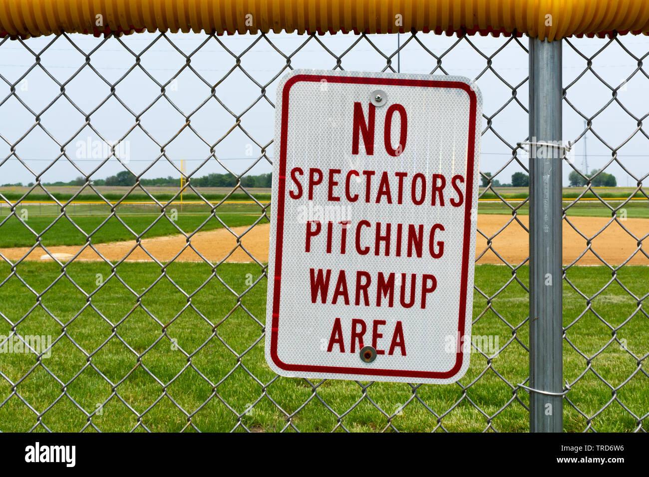No spectator pitching warmup area sign on fence with baseball/ softball ...