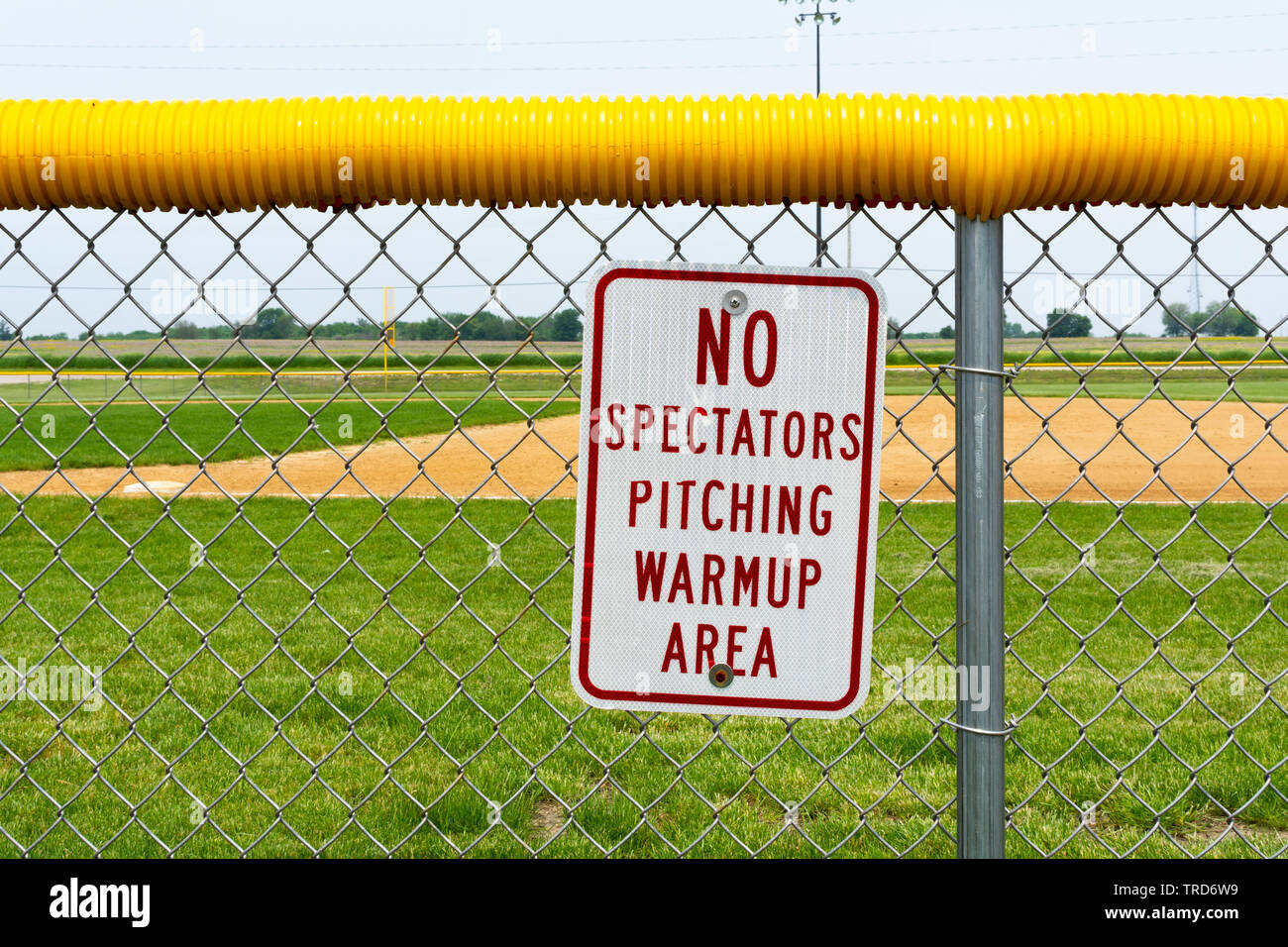 No spectator pitching warmup area sign on fence with baseball/ softball ...