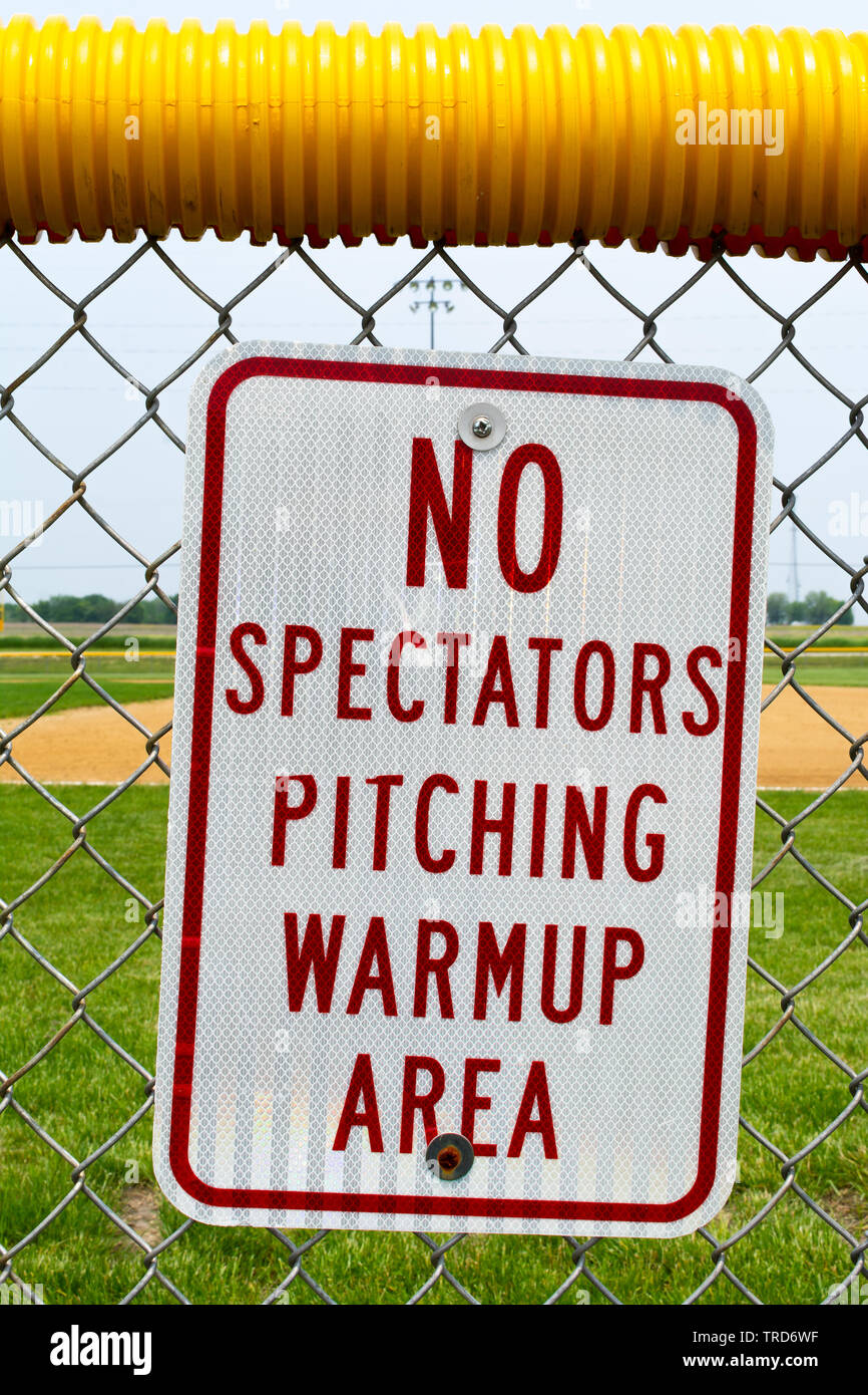 No spectator pitching warmup area sign on fence with baseball/ softball ...