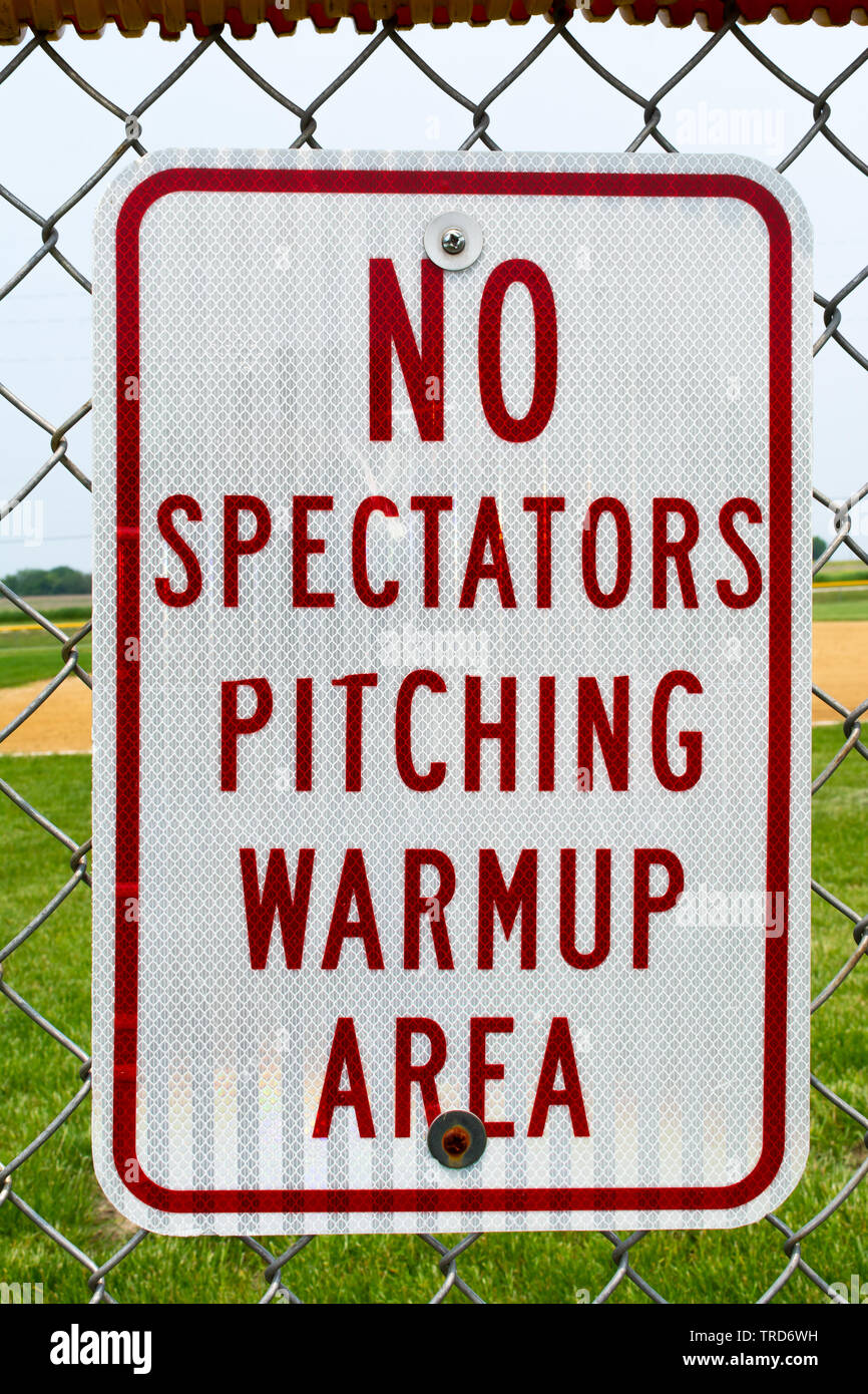 No spectator pitching warmup area sign on fence with baseball/ softball ...