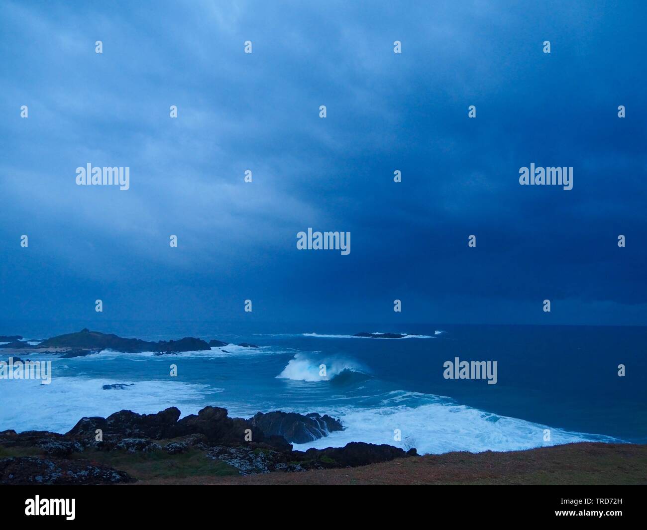The dark shades of blue colours of a dramatic stormy sea and sky storm ...