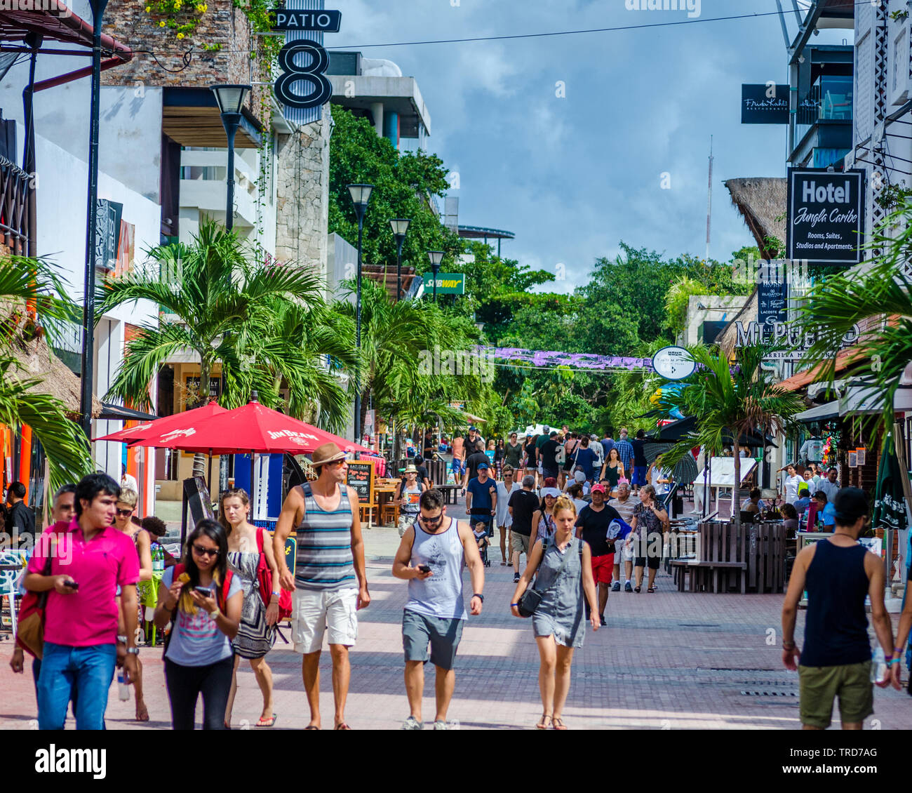 Street full of people walking around, exploring, eating, drinking and ...