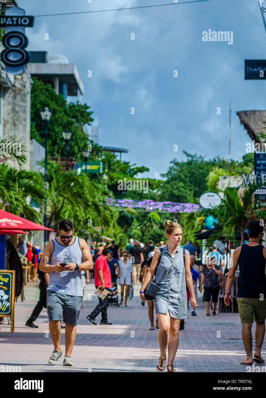 Street full of people walking around, exploring, eating, drinking and ...