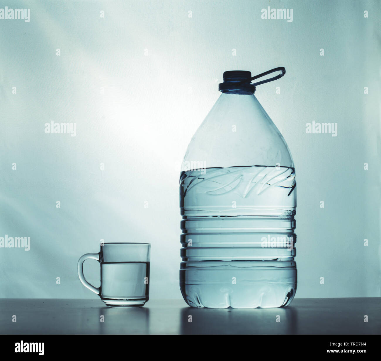 close up of glass of water and big bottle Stock Photo - Alamy