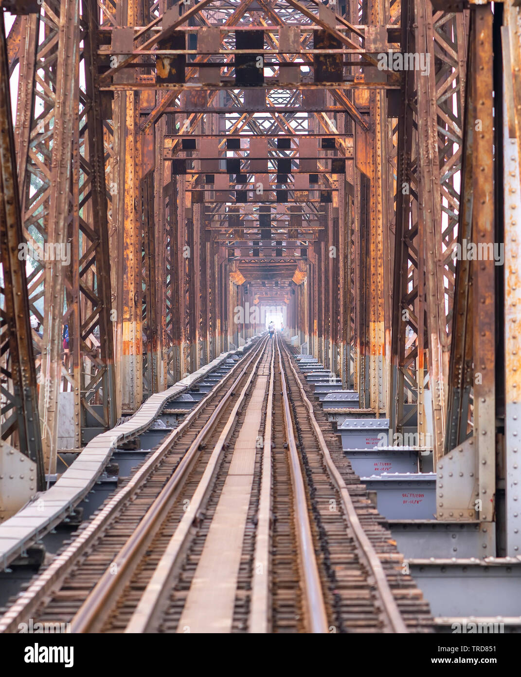 Vintage railroad tracks leading over the famous Long Bien Bridge, Hanoi ...