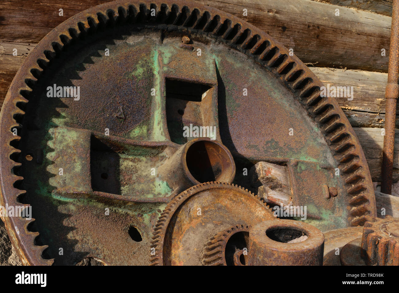 Very old and rusty huge rural metal device mechanical parts lying near ...
