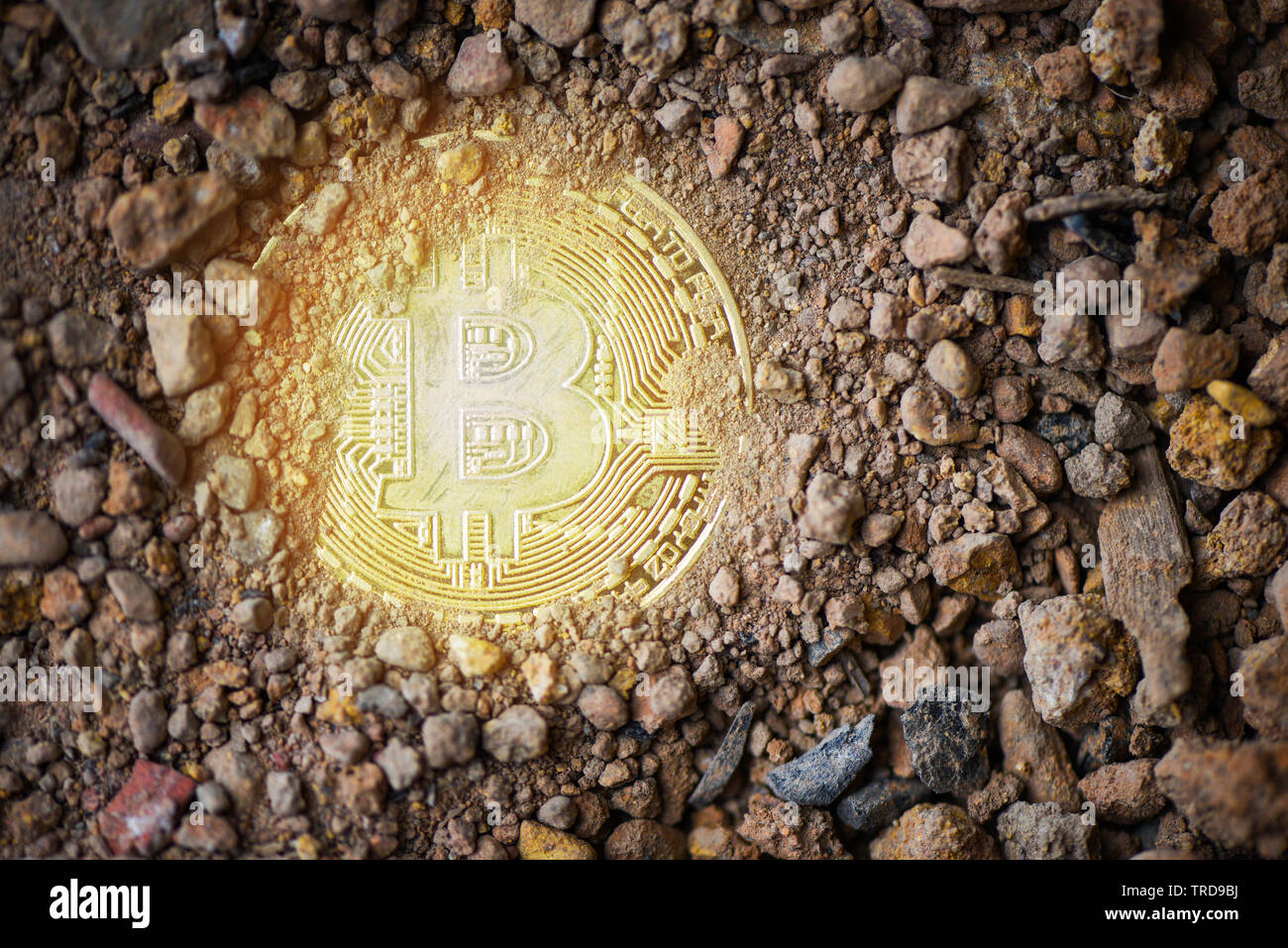 Bitcoin Golden on ground soil deep with light / Virtual cryptocurrency ...