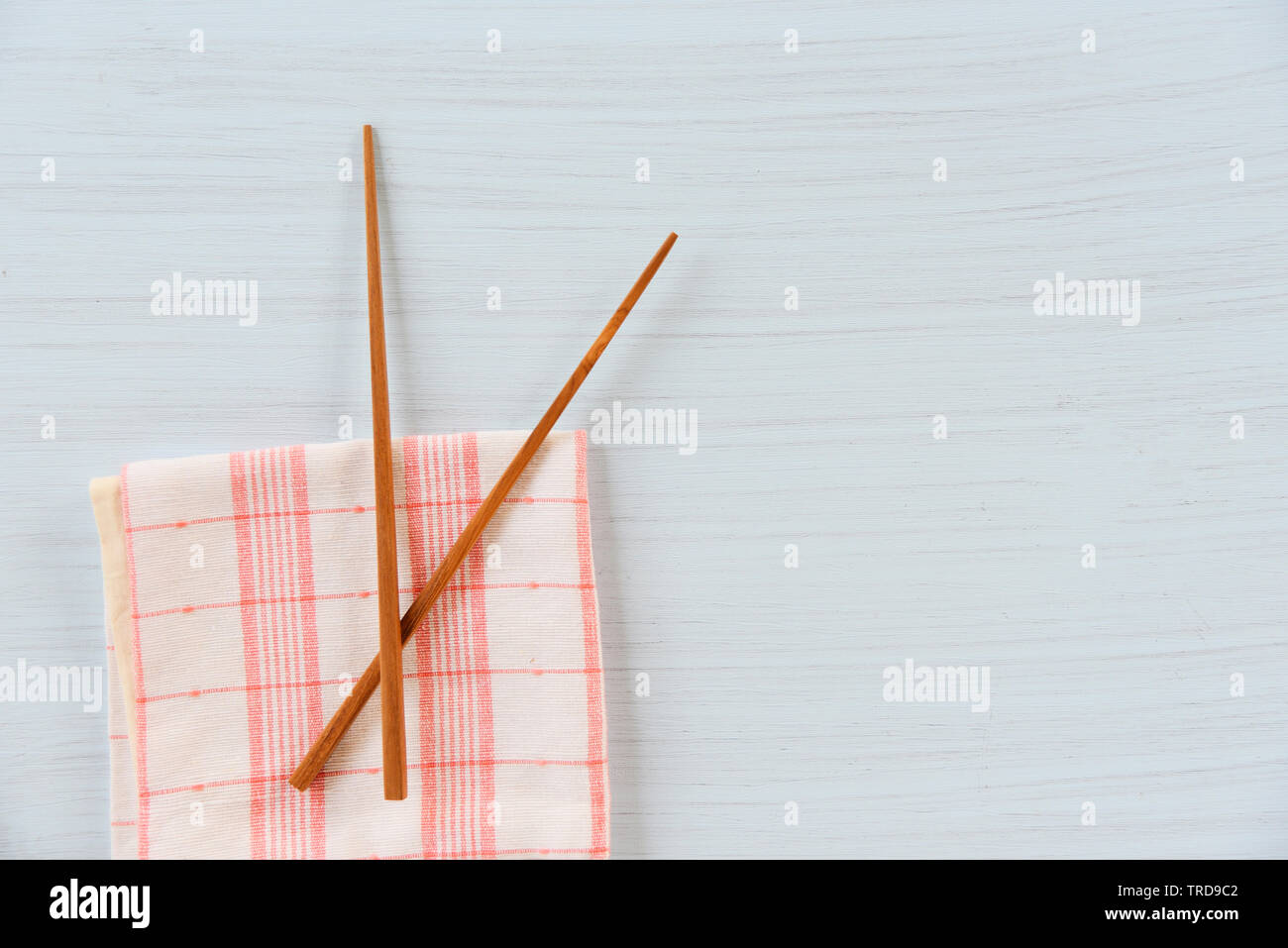 Wooden chopsticks kitchenware set on napery on dining table / Zero ...