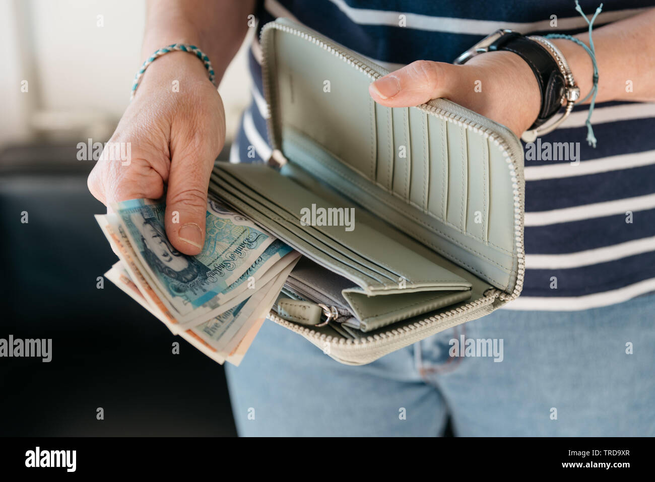 Woman taking money from pocket hi-res stock photography and images - Alamy