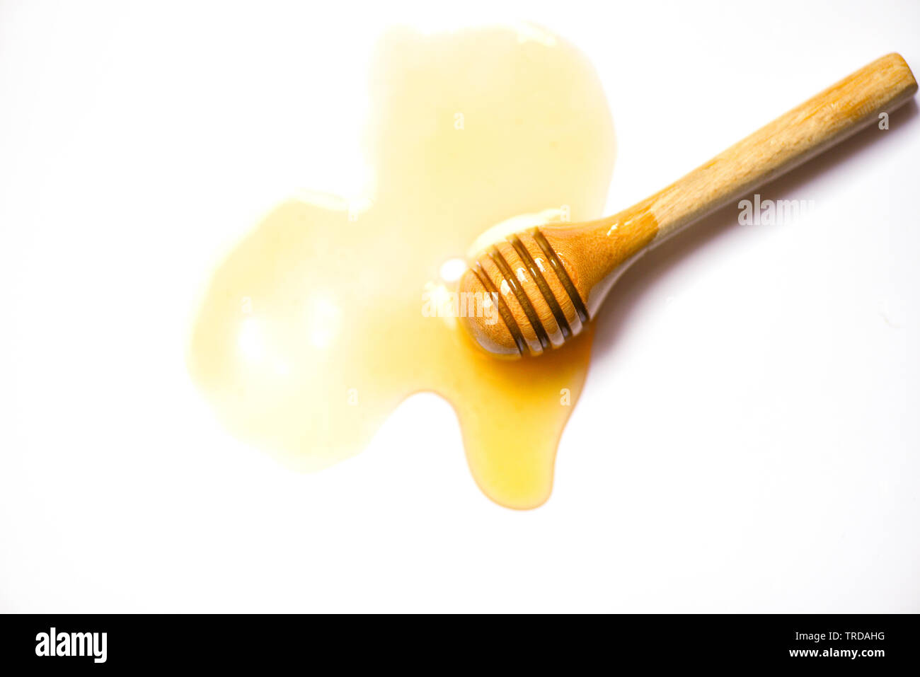 Wooden dipper honey yellow sweet on white background Stock Photo - Alamy