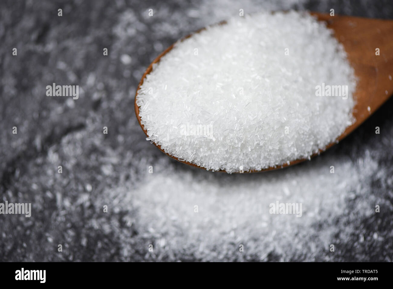 MSG / Monosodium glutamate on wooden spoon with dark background Stock ...