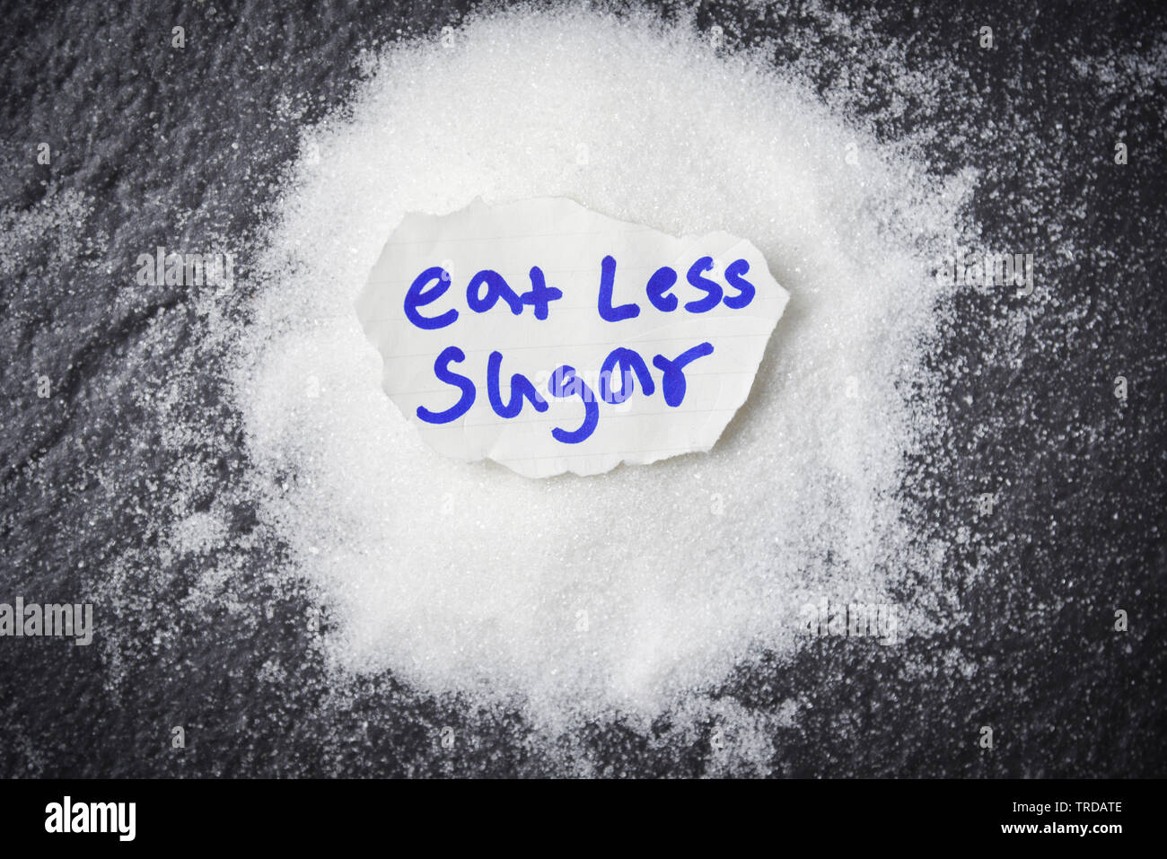eat less sugar for health concept / Heap of white sugar on dark ...