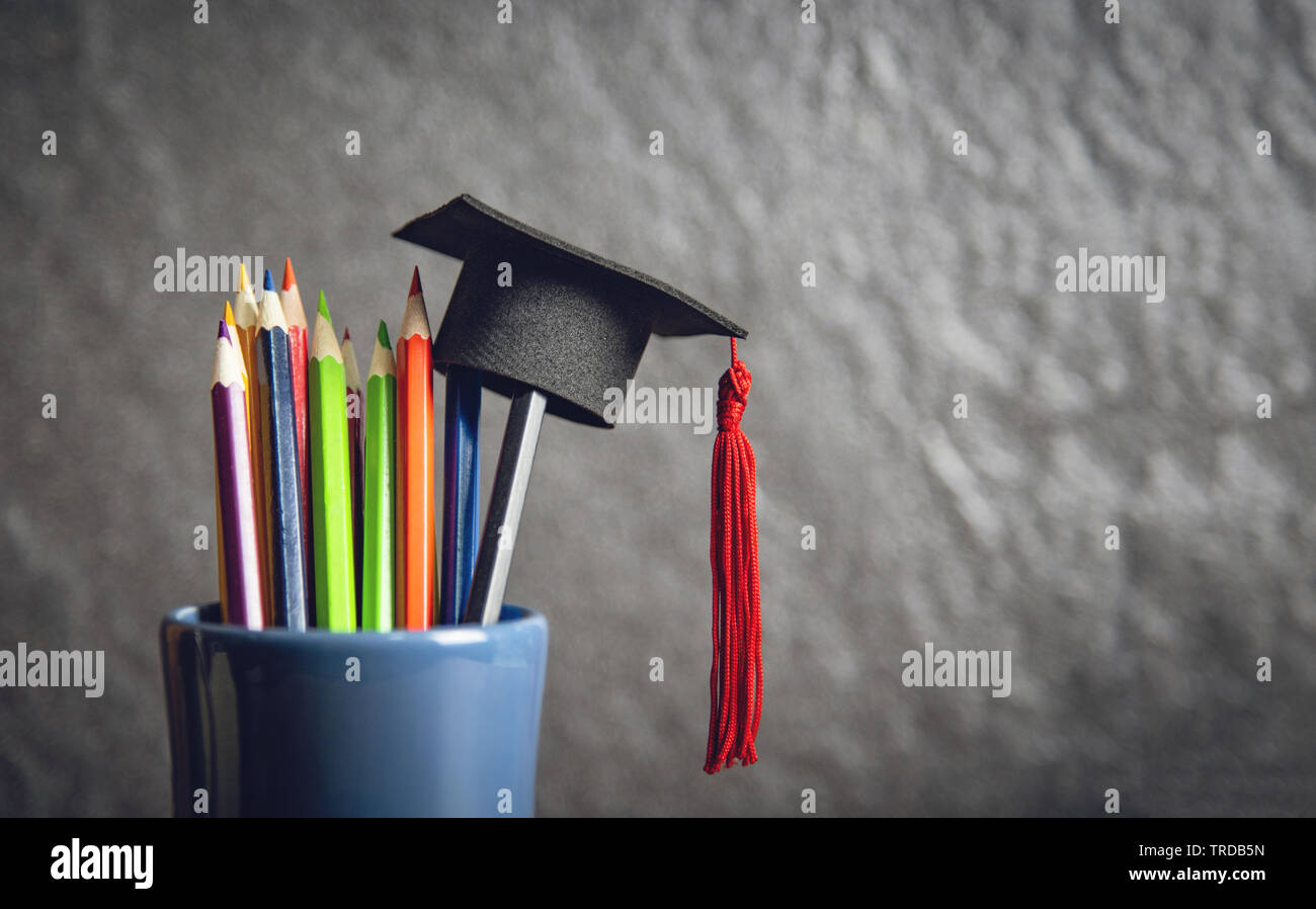 Education and back to school concept with graduation cap on pencils ...